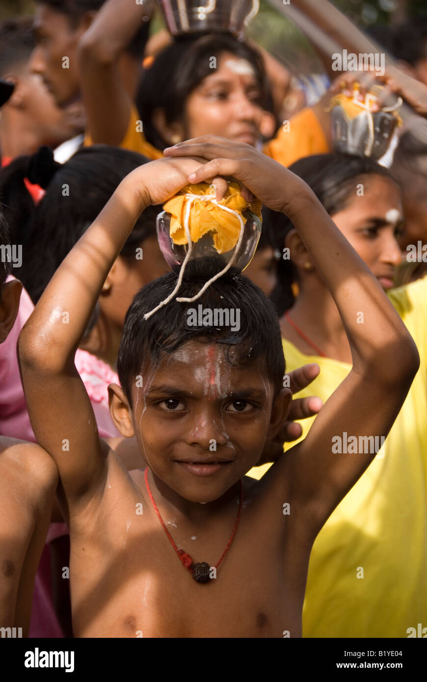 YOUNG DEVOTEE CARRYING POT OF MILK OFFERING AT THE ANNUAL HINDU ...