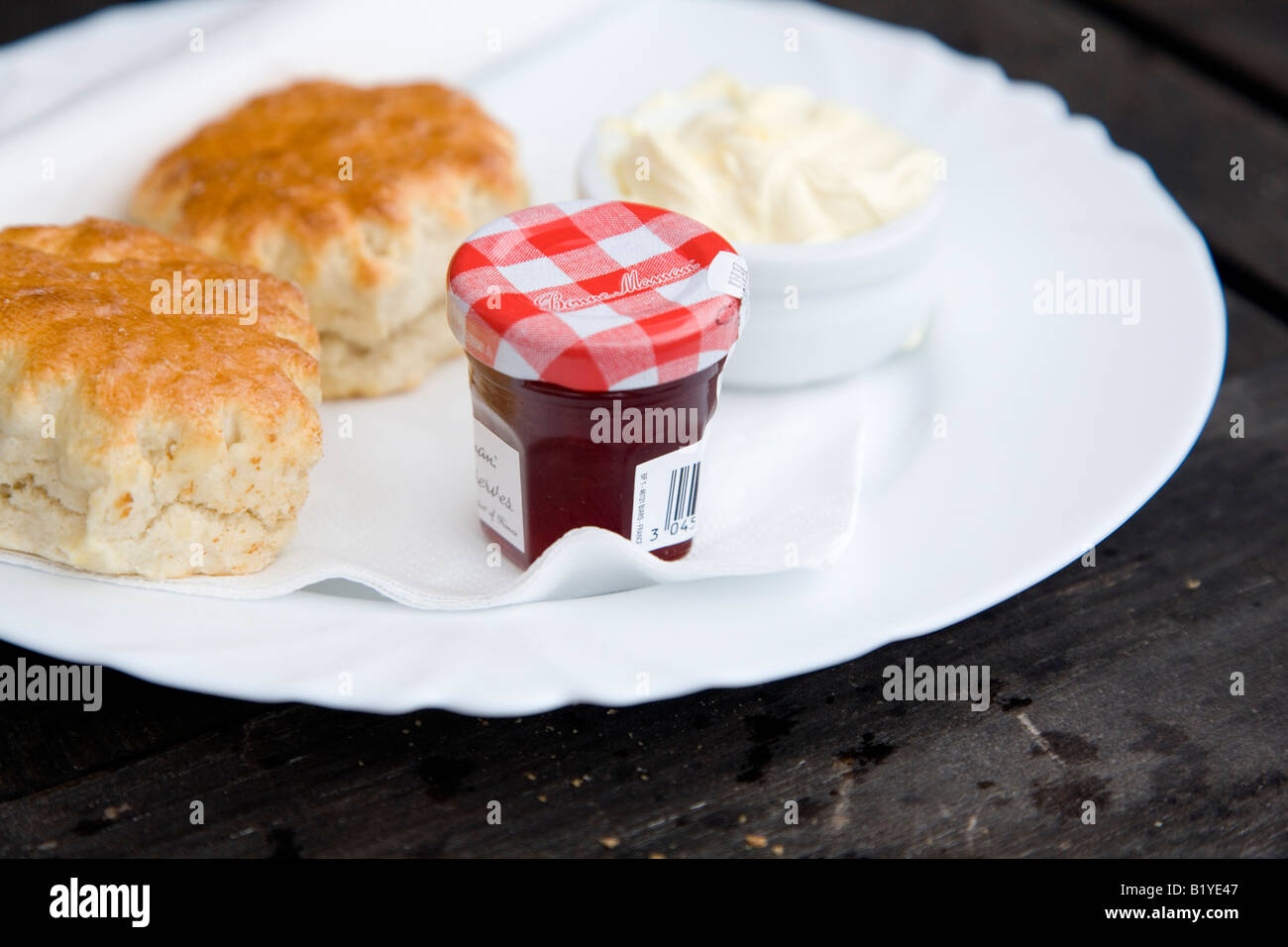 A traditional English Cream Tea comprising tea scones jam and cream ...