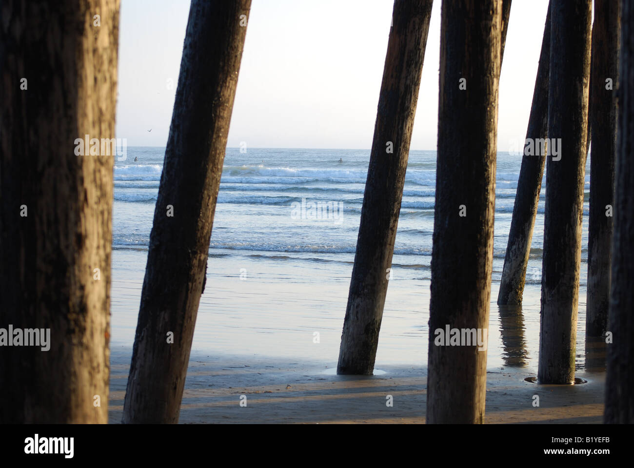 Waves Through Pillars of a Pier Stock Photo - Alamy