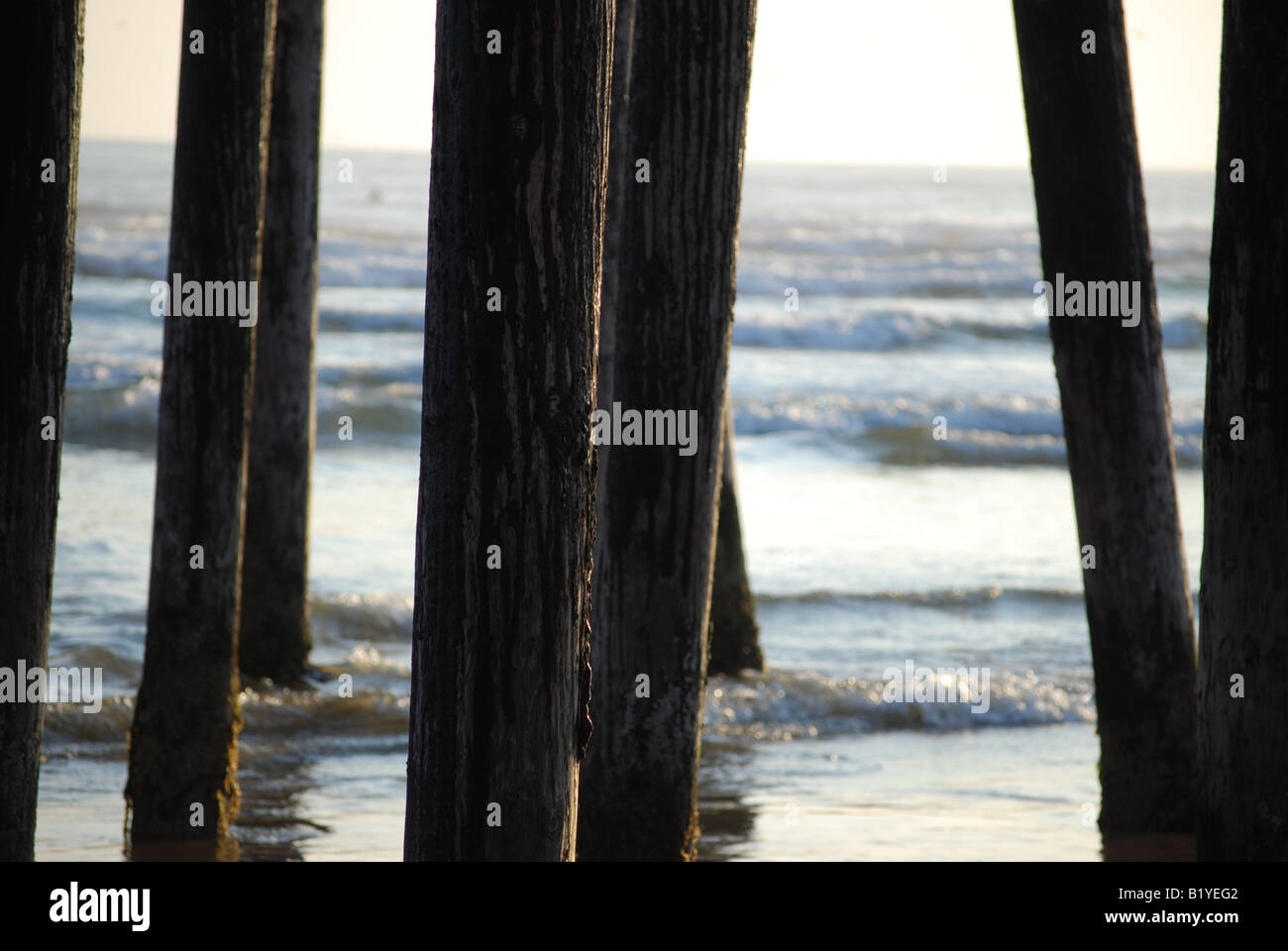 Waves Through Pillars of a Pier Stock Photo - Alamy