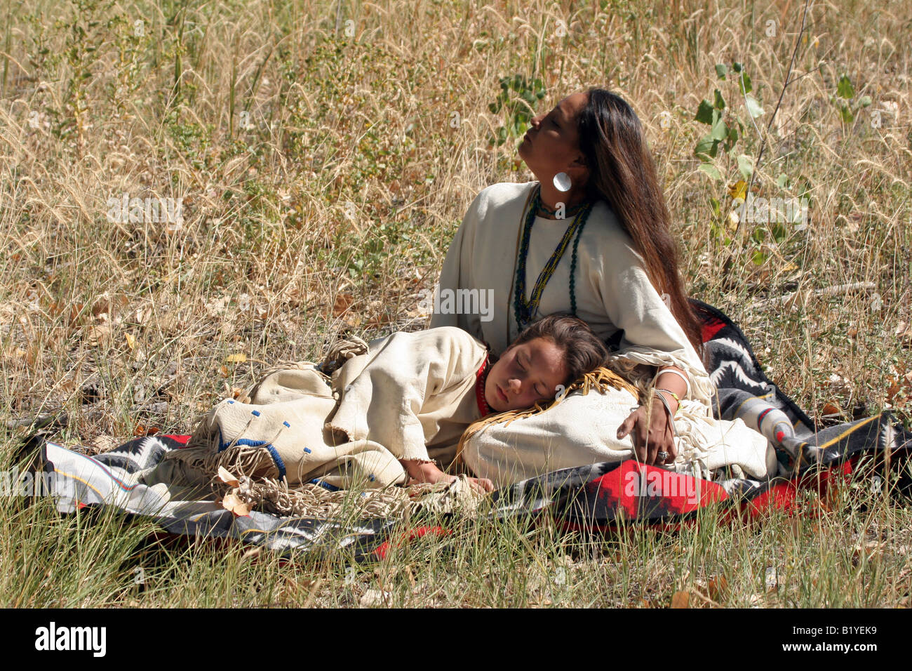 A Native American Sioux Indian mother looking up at the sun and her ...