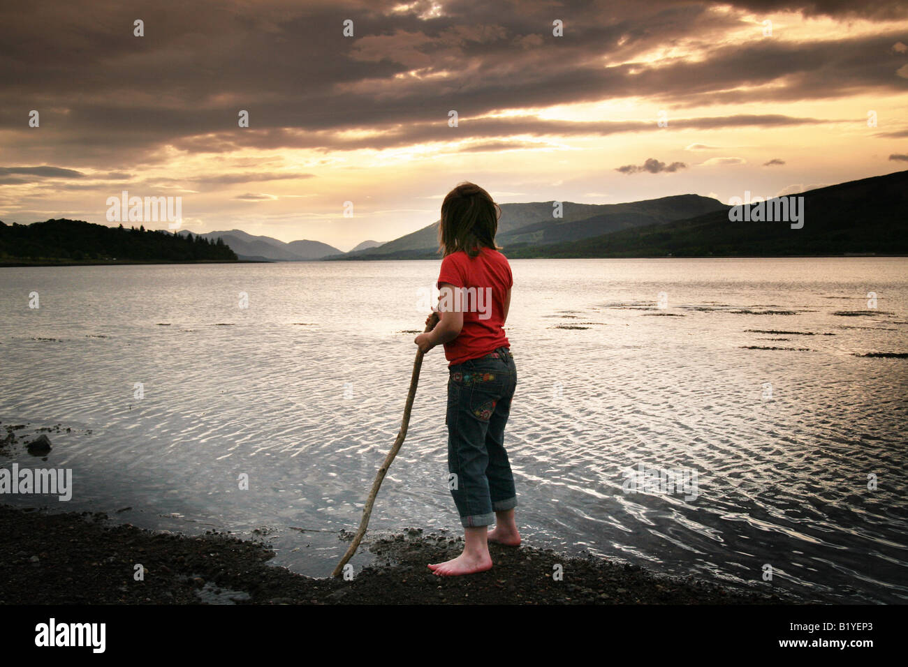 young girl stood at edge of loch Stock Photo - Alamy