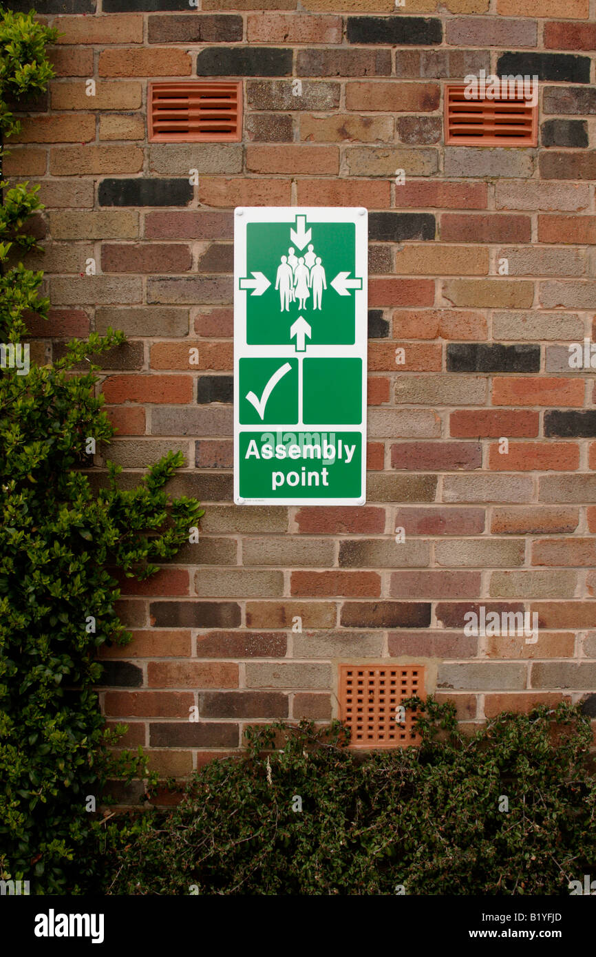 Fire assembly point sign on brick wall close up England UK Stock Photo ...