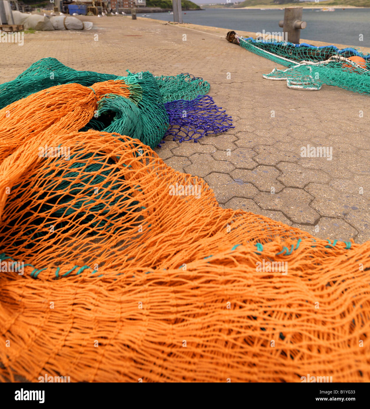 Multi-coloured fishing nets on quay-side Stock Photo - Alamy