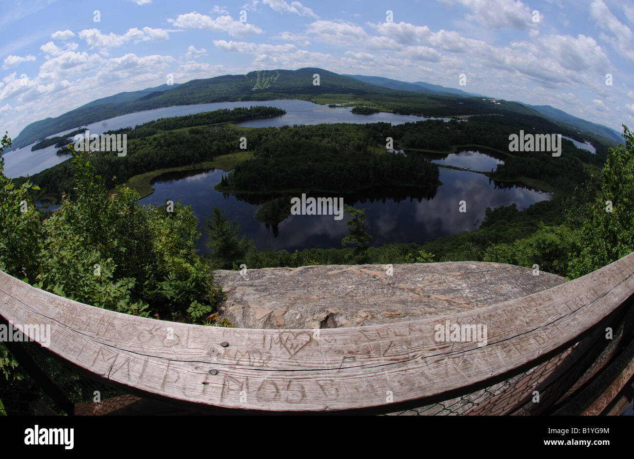 Fisheye view of lakes and a ski hill from a lookout at the summit of a ...