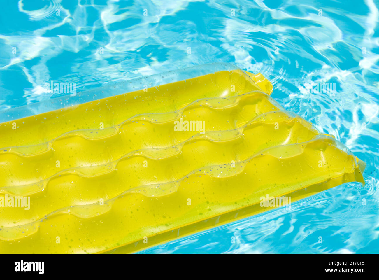 A yellow raft drifts in a swimming pool Stock Photo - Alamy
