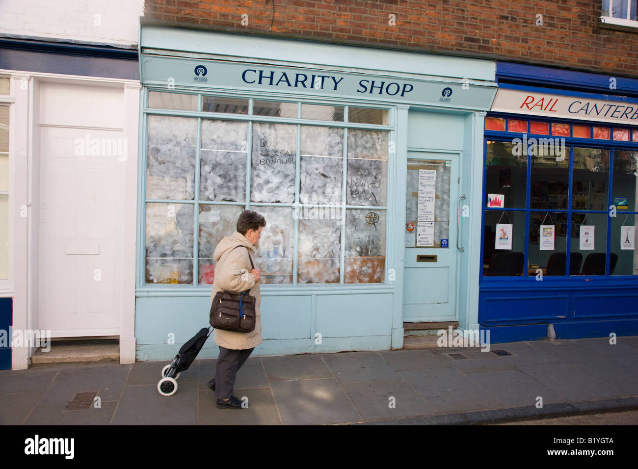 Charity shop closed down with whitewashed windows Stock Photo - Alamy