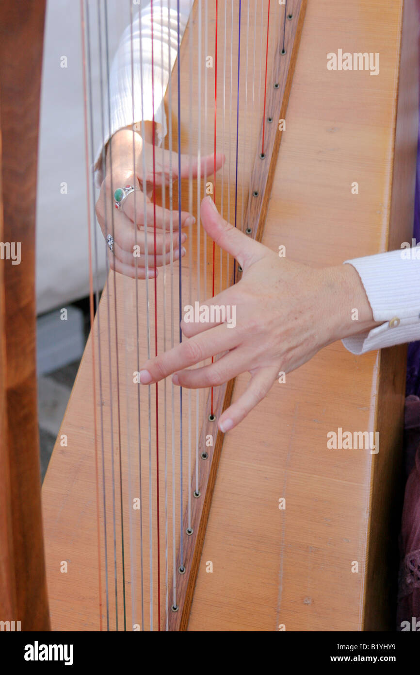 Playing the harp with both hands Stock Photo - Alamy