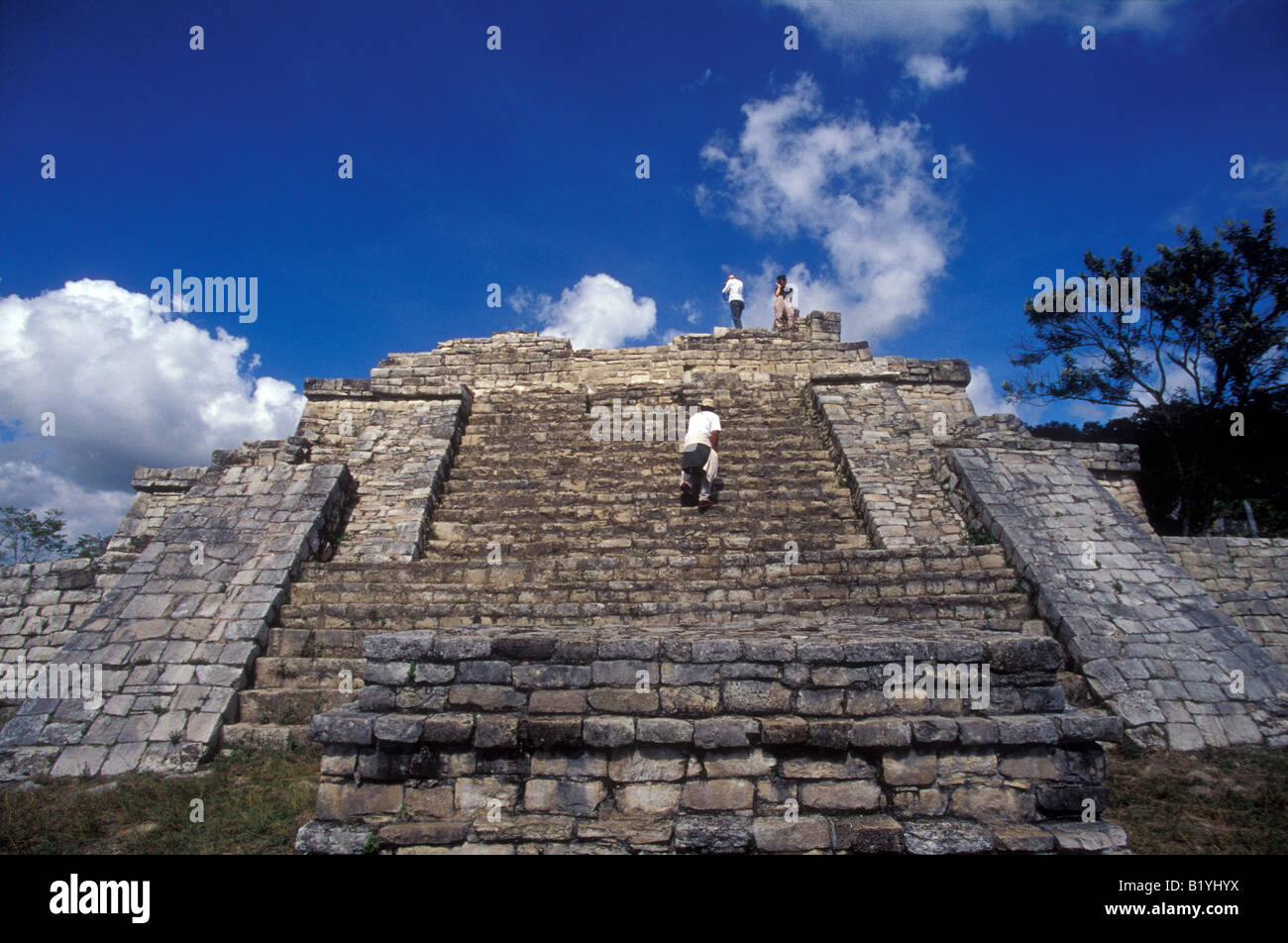 Tourists scaling the Acropolis the main structure at at the Mayan ruins ...