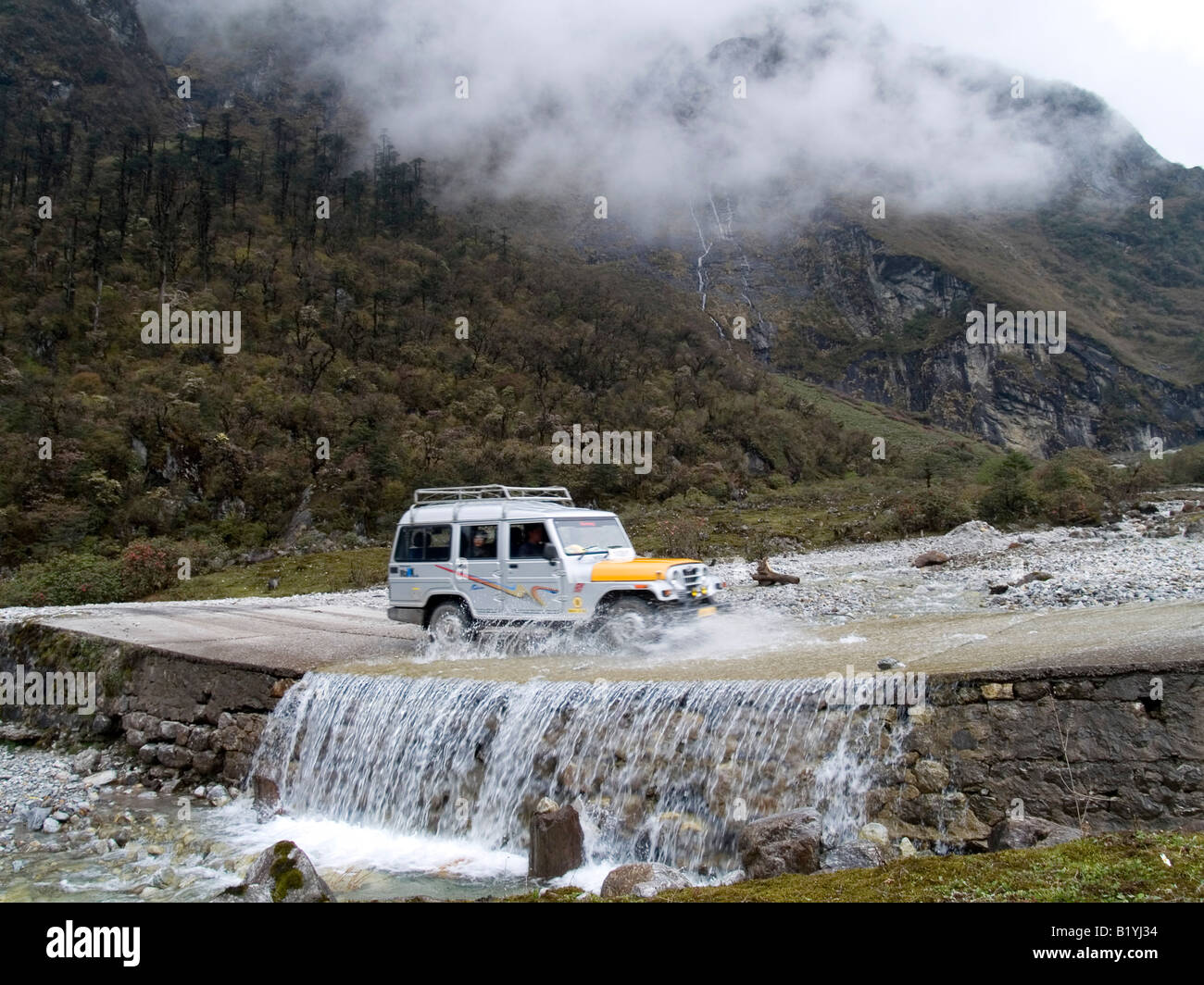 tourist jeep crossing a river in northern Sikkim in India Stock Photo ...