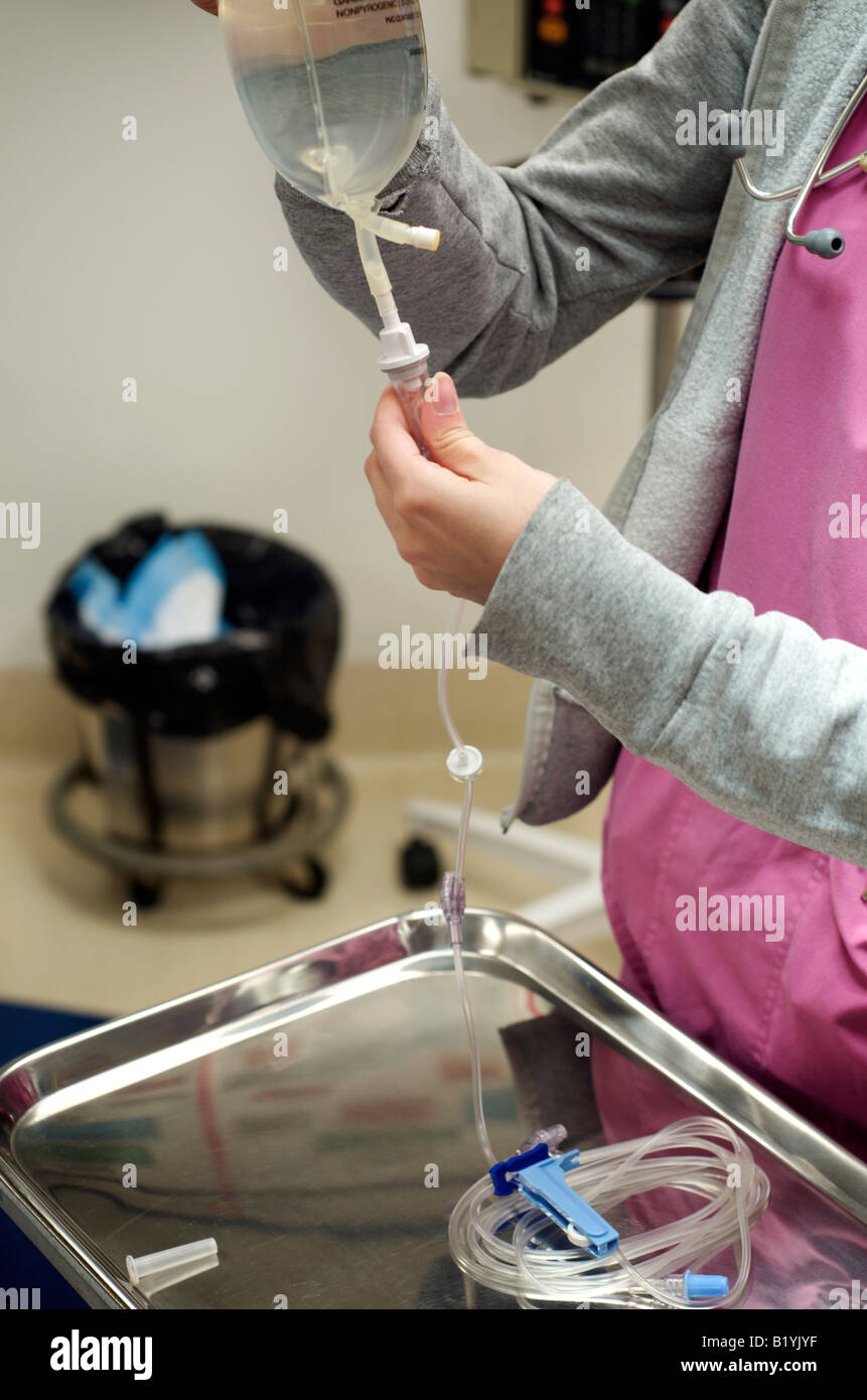Nurse prepping an IV in a hospital Stock Photo - Alamy