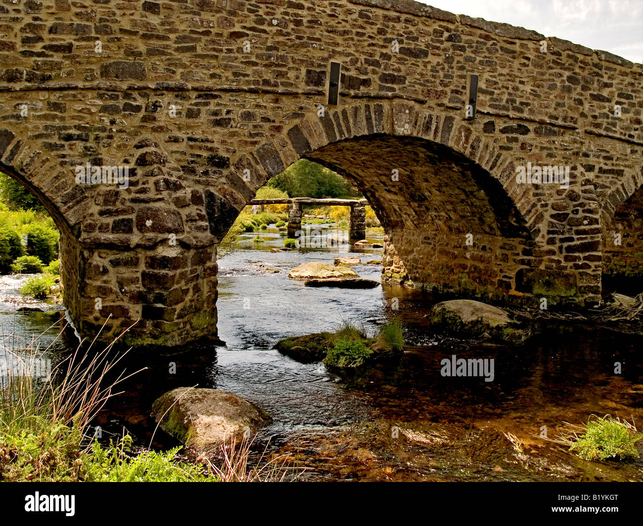 Ancient Clapper bridge at Postbridge Devon seen through more modern ...