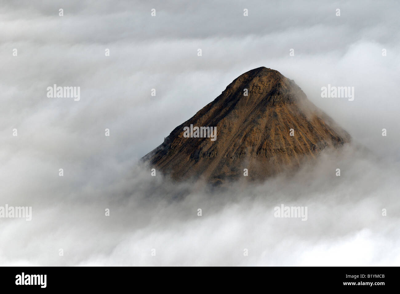 Sleepy mountain in the Yukon Territory on a foggy cloudy summer day ...