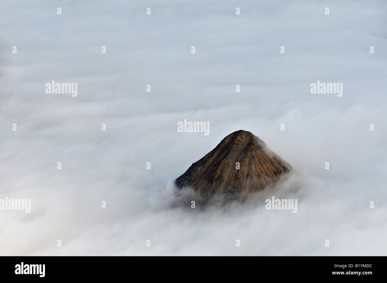Sleepy mountain in the Yukon Territory on a foggy cloudy summer day ...