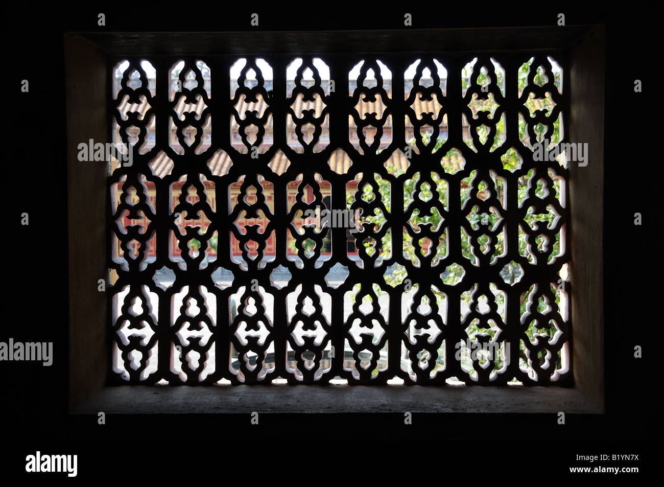 Looking through an elaborate window at the Old Citadel Hue Vietnam ...