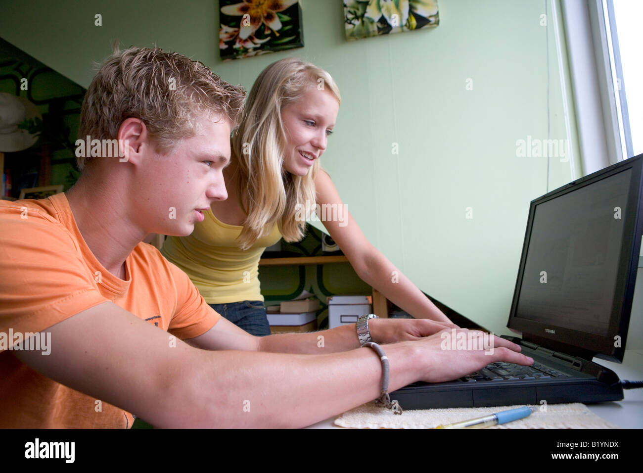 Teenage boy and girl behind computer Stock Photo - Alamy