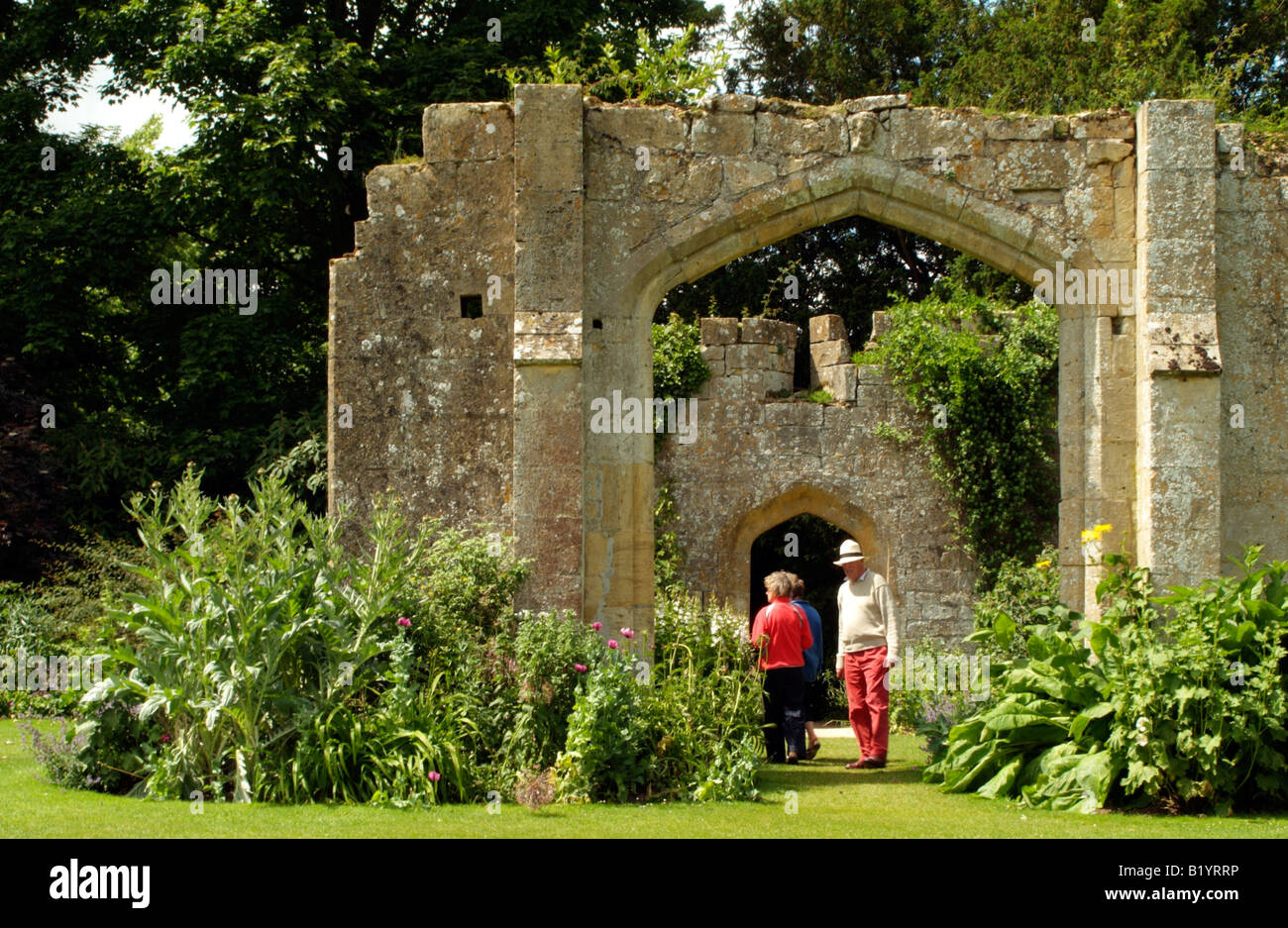 Visitors in the gardens of the Tithe Barn ruins at Sudeley Castle ...