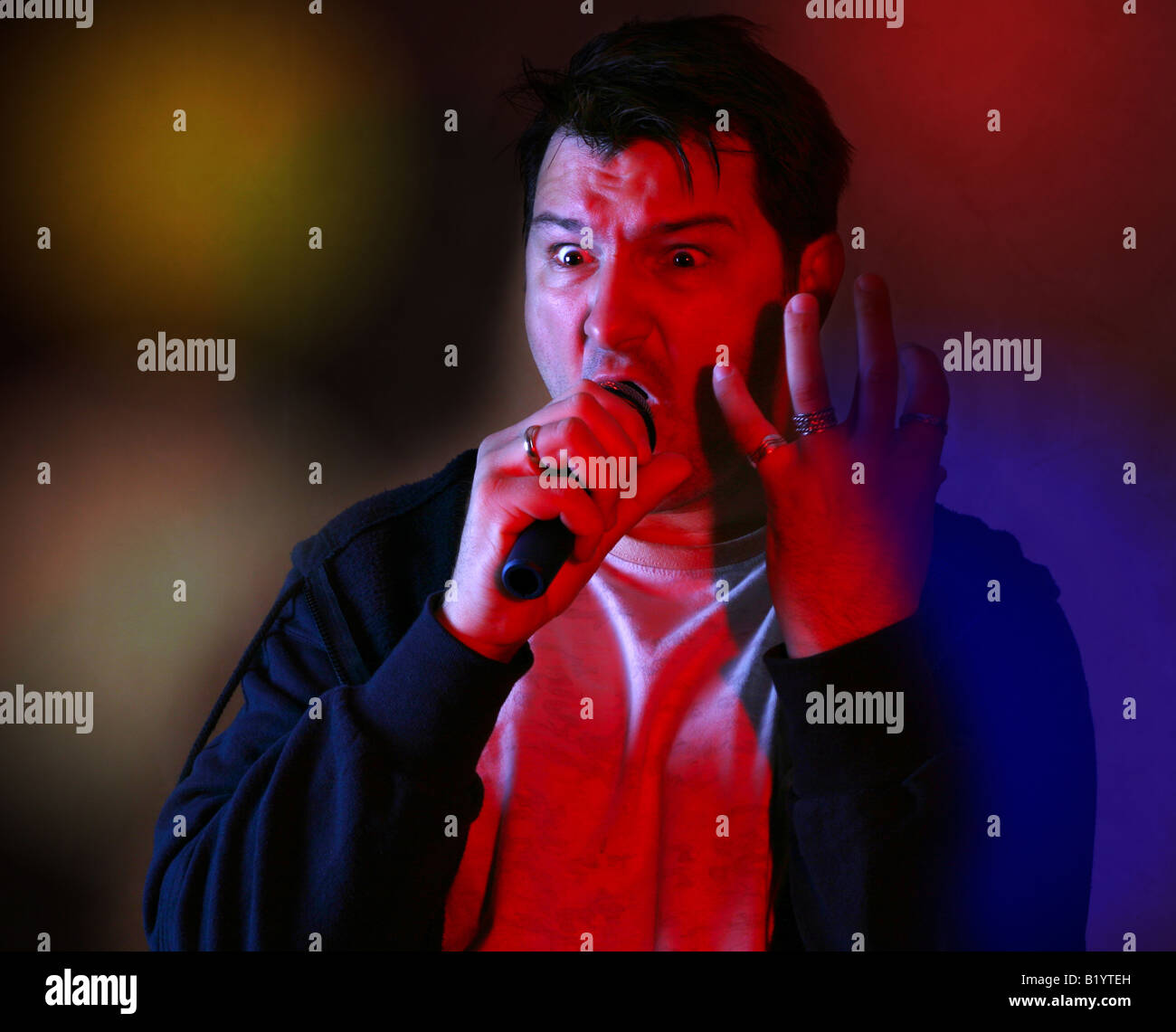 Rock singer on a scene singing rock in ecstasy Stock Photo - Alamy