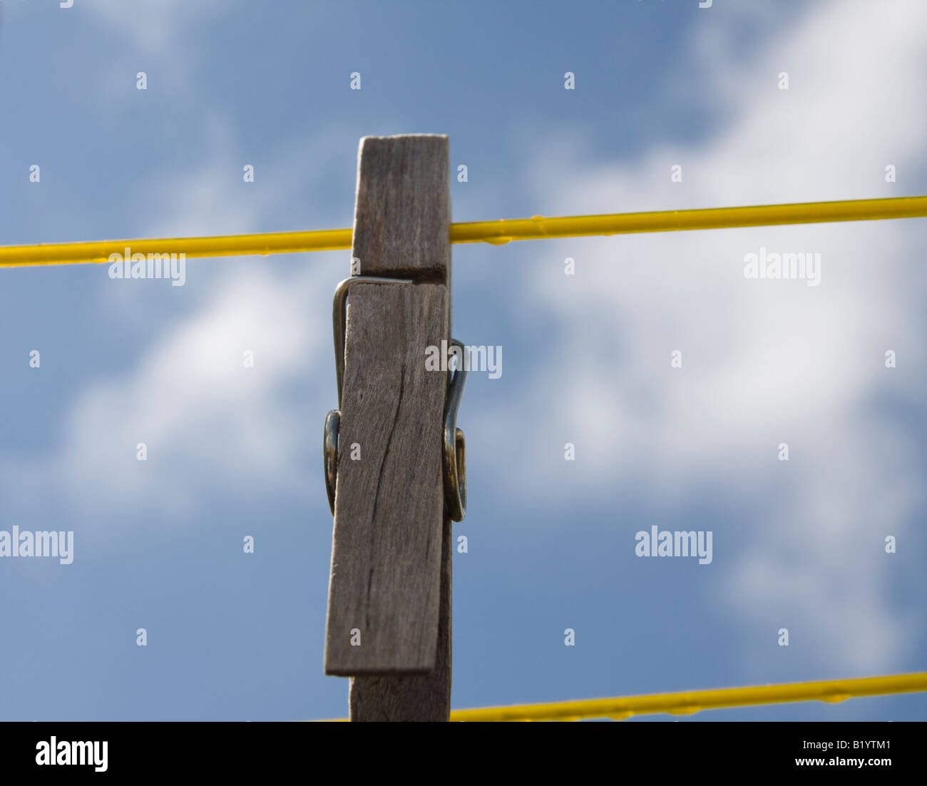 Single wooden clothes peg on a washing line against a blue sky Stock ...