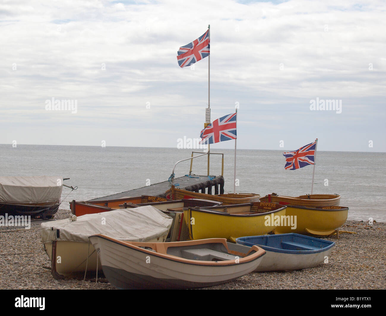 Boat and flags on beach Stock Photo - Alamy