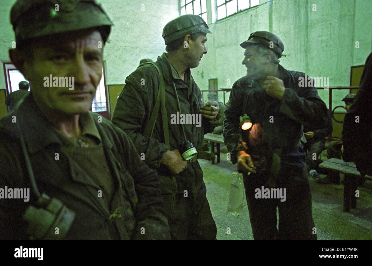 romanian miners in petrila are smoking before beginning their shift ...