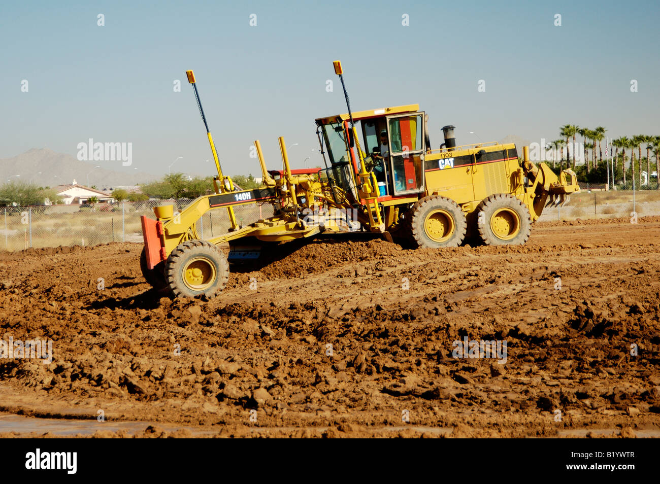 Heavy construction equipment at work on a commercial construction site ...