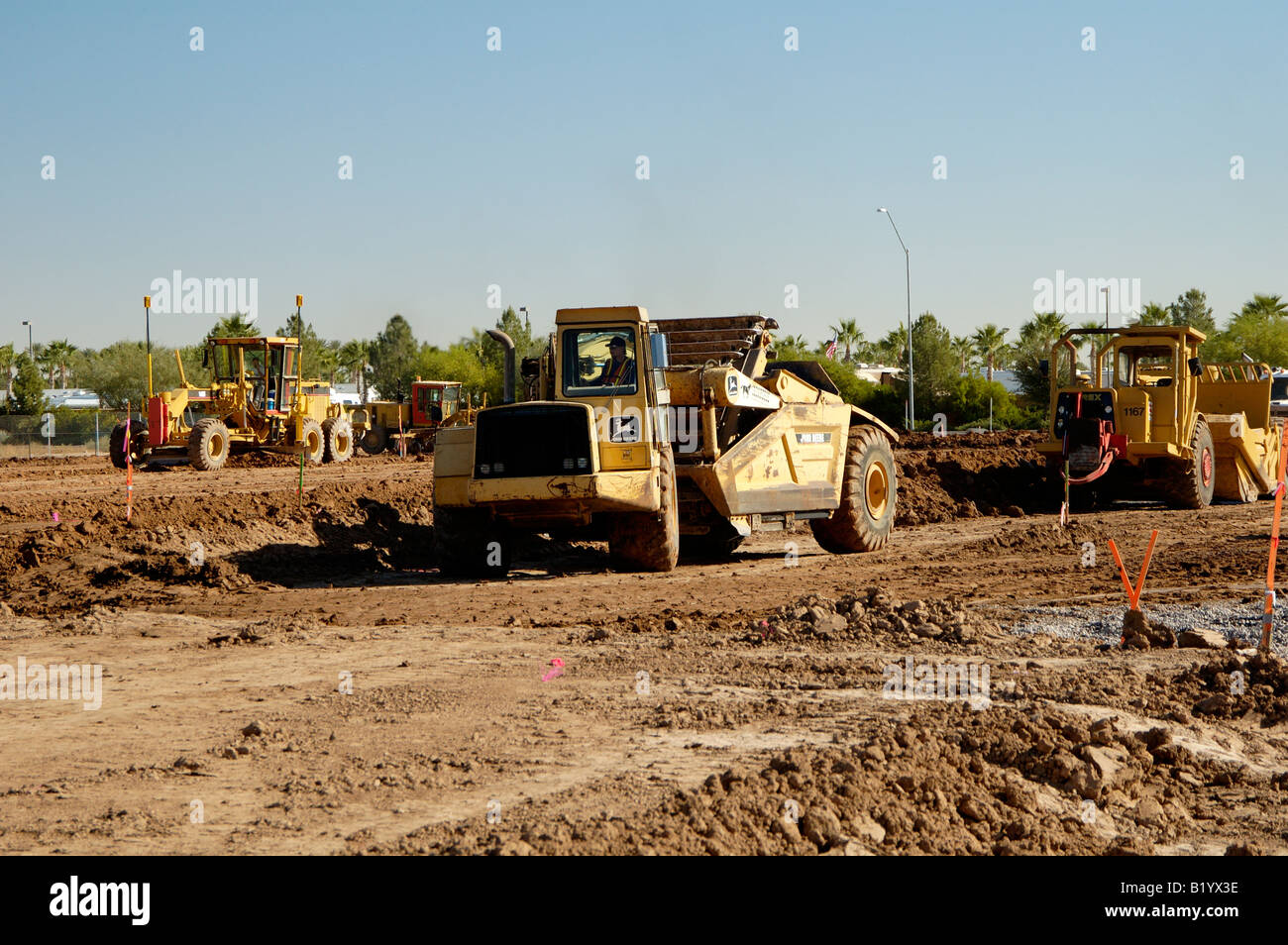 Heavy construction equipment at work on a commercial construction site ...