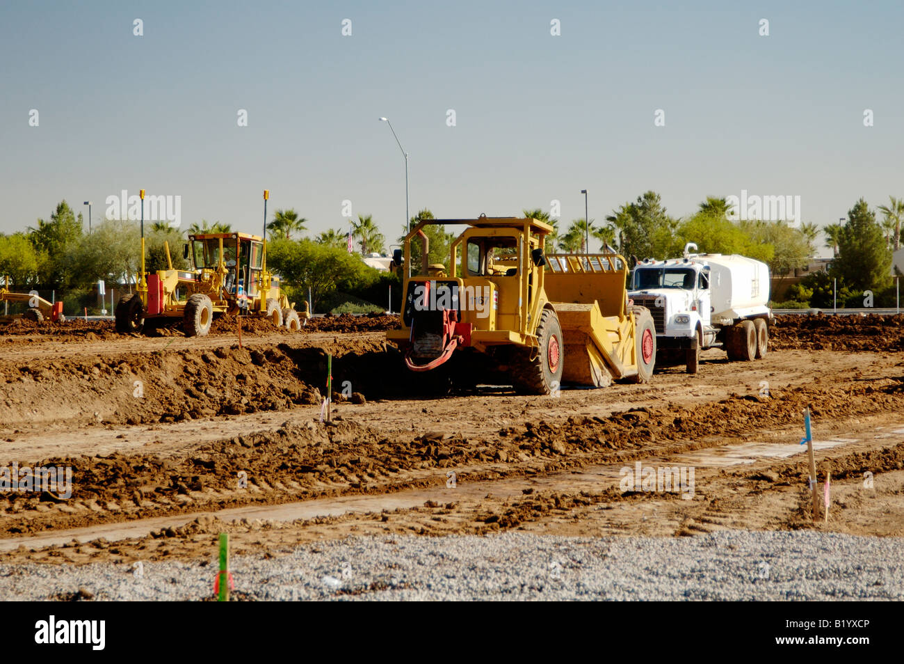 Heavy construction equipment at work on a commercial construction site ...
