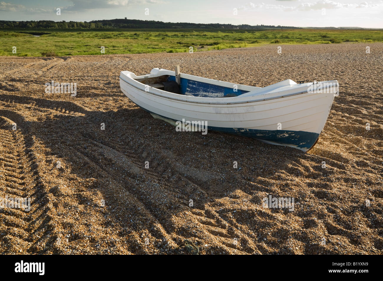 single small boat beached on the shingle beach at Blakeney, North ...
