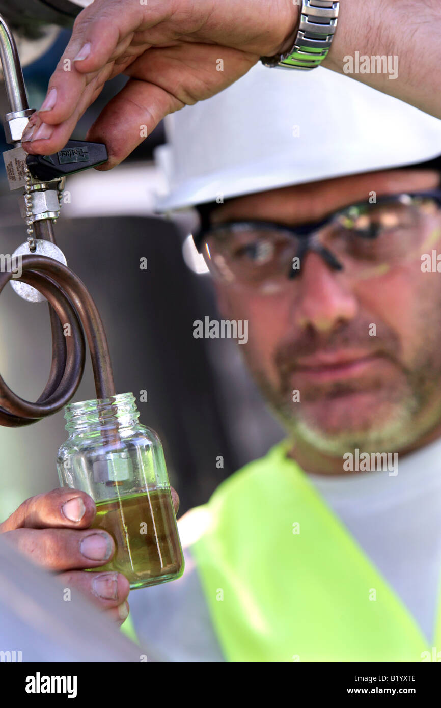 An engineer takes a sample of biodiesel at a plant on Teesside, UK ...
