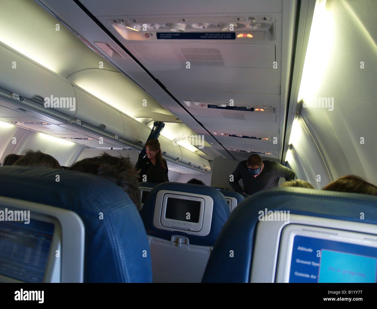 Cabin of in flight passenger airplane Stock Photo - Alamy