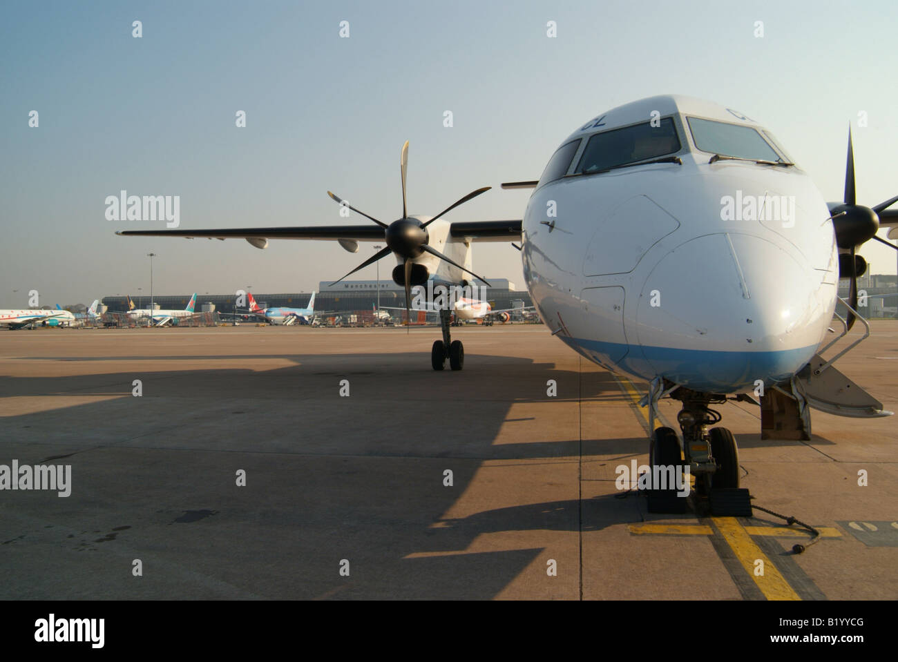 A parked Dash8 400 aircraft viewed from infront and shown against ...