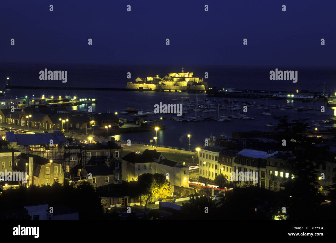 St Peterport harbour and Castle Cornet, Guernsey at night Stock Photo ...