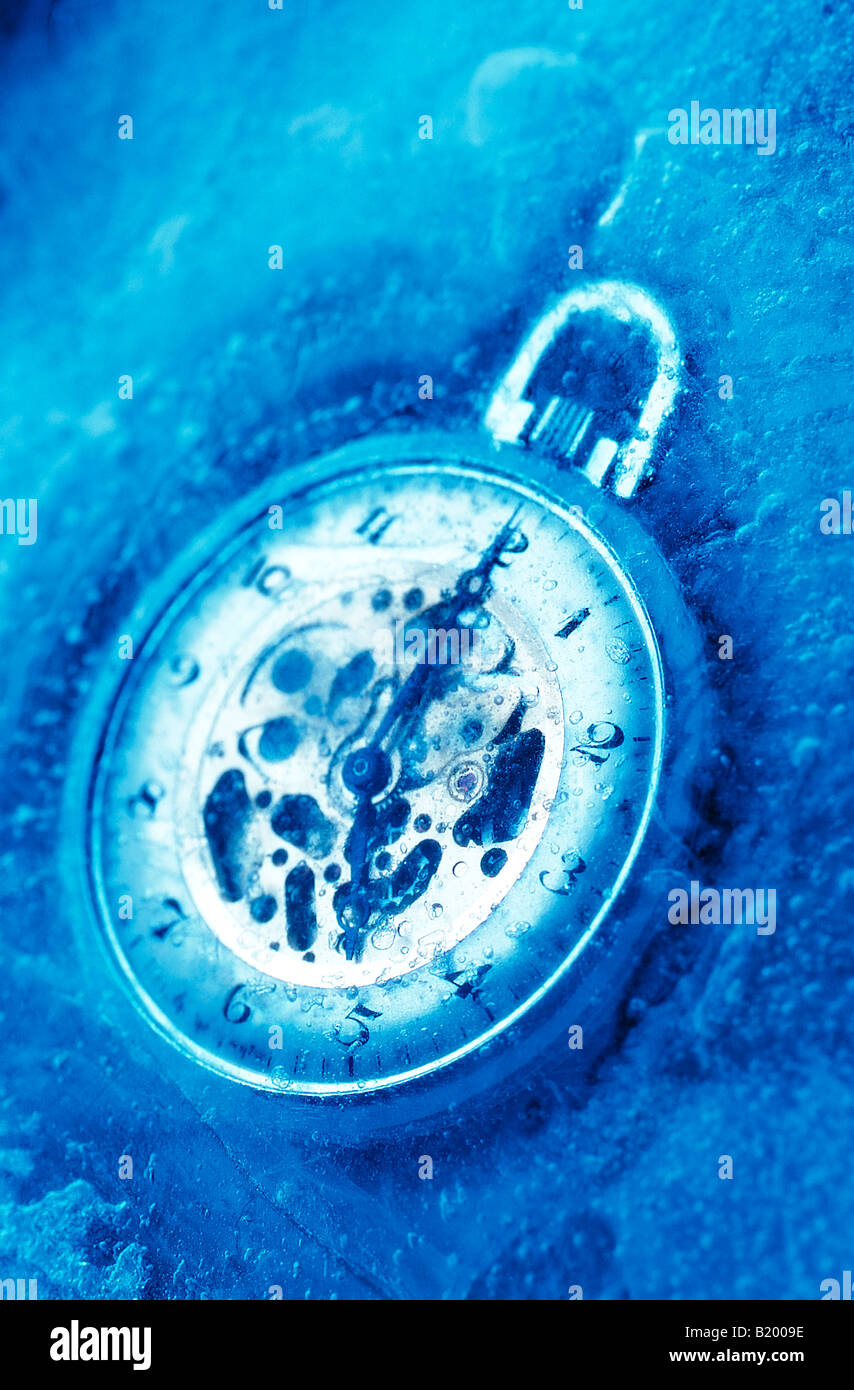 Pocket watch frozen in ice Stock Photo - Alamy