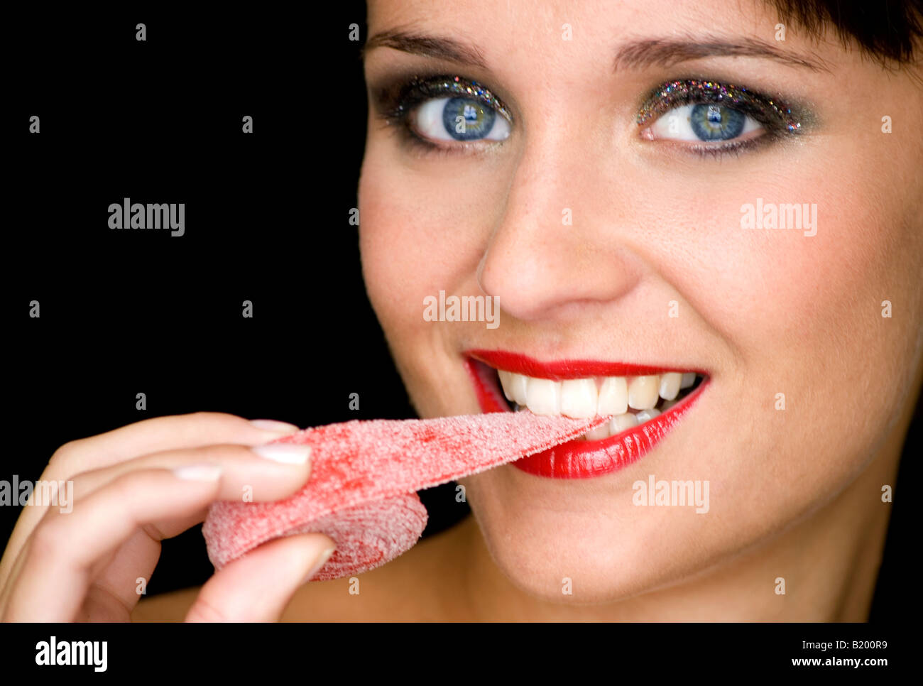 woman biting strawberry string sweet Stock Photo - Alamy