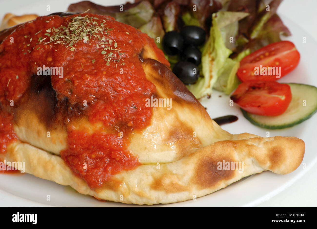 Italian food calzone with marinara sauce Stock Photo - Alamy