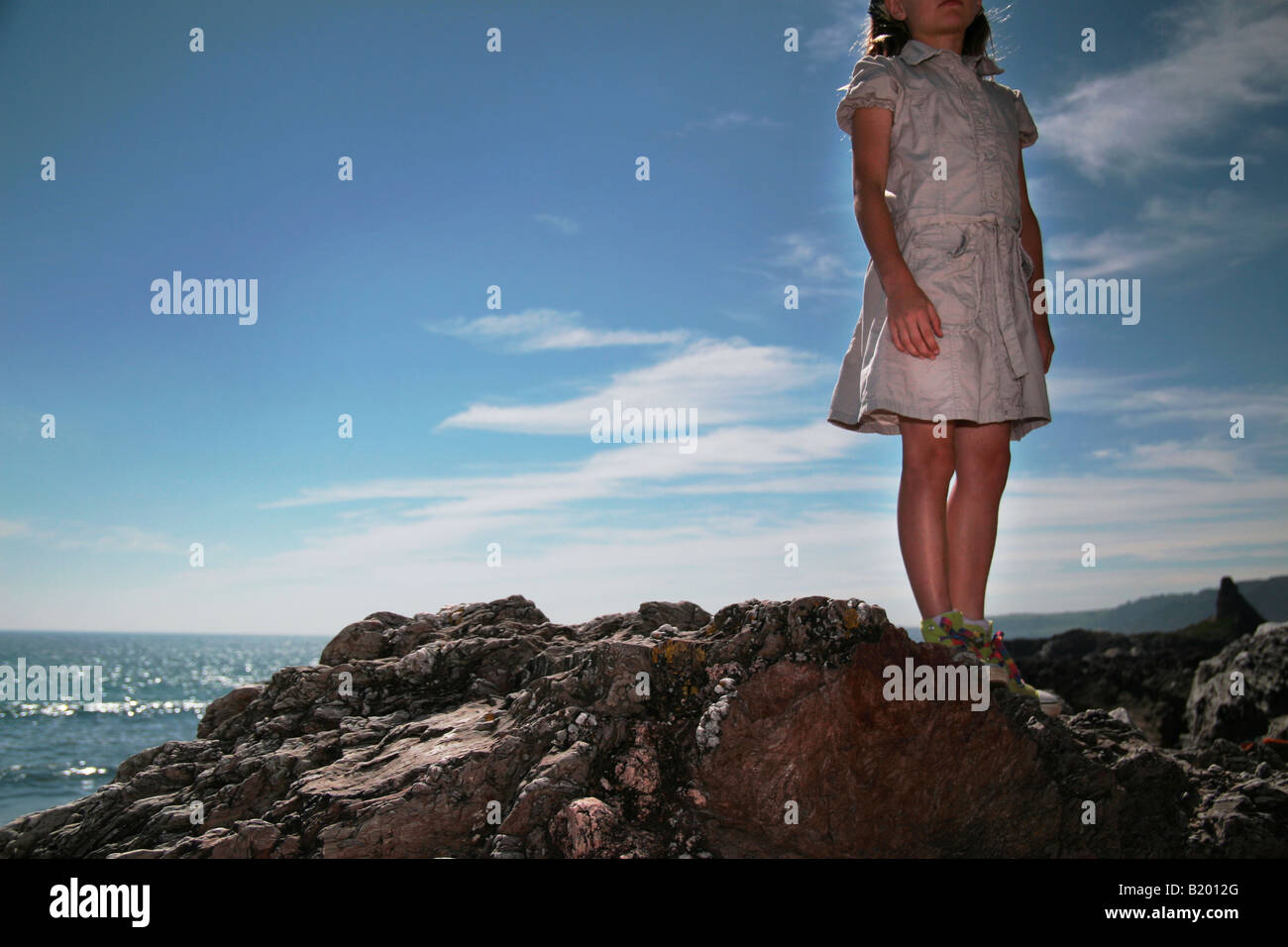 young girl stood on rocks Stock Photo - Alamy