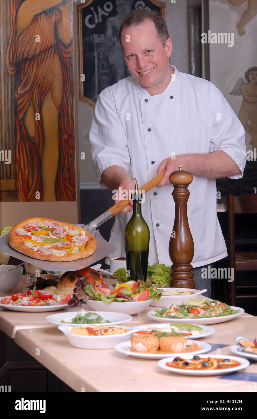 Pizza Chef in Italian restaurant with selection of dishes Stock Photo ...