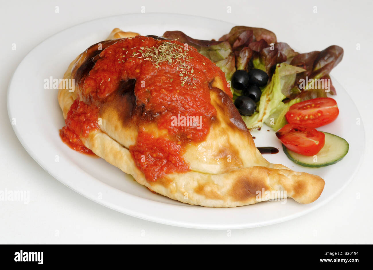 Calzone with marinara sauce in an Italian restaurant Stock Photo - Alamy
