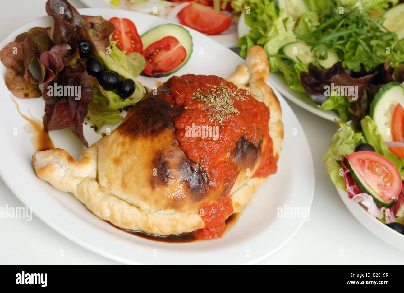 Calzone with marinara sauce in an Italian restaurant Stock Photo - Alamy