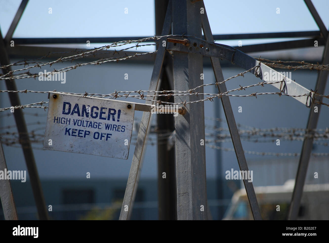 Danger Sign on High Tension Electrical Tower Stock Photo - Alamy
