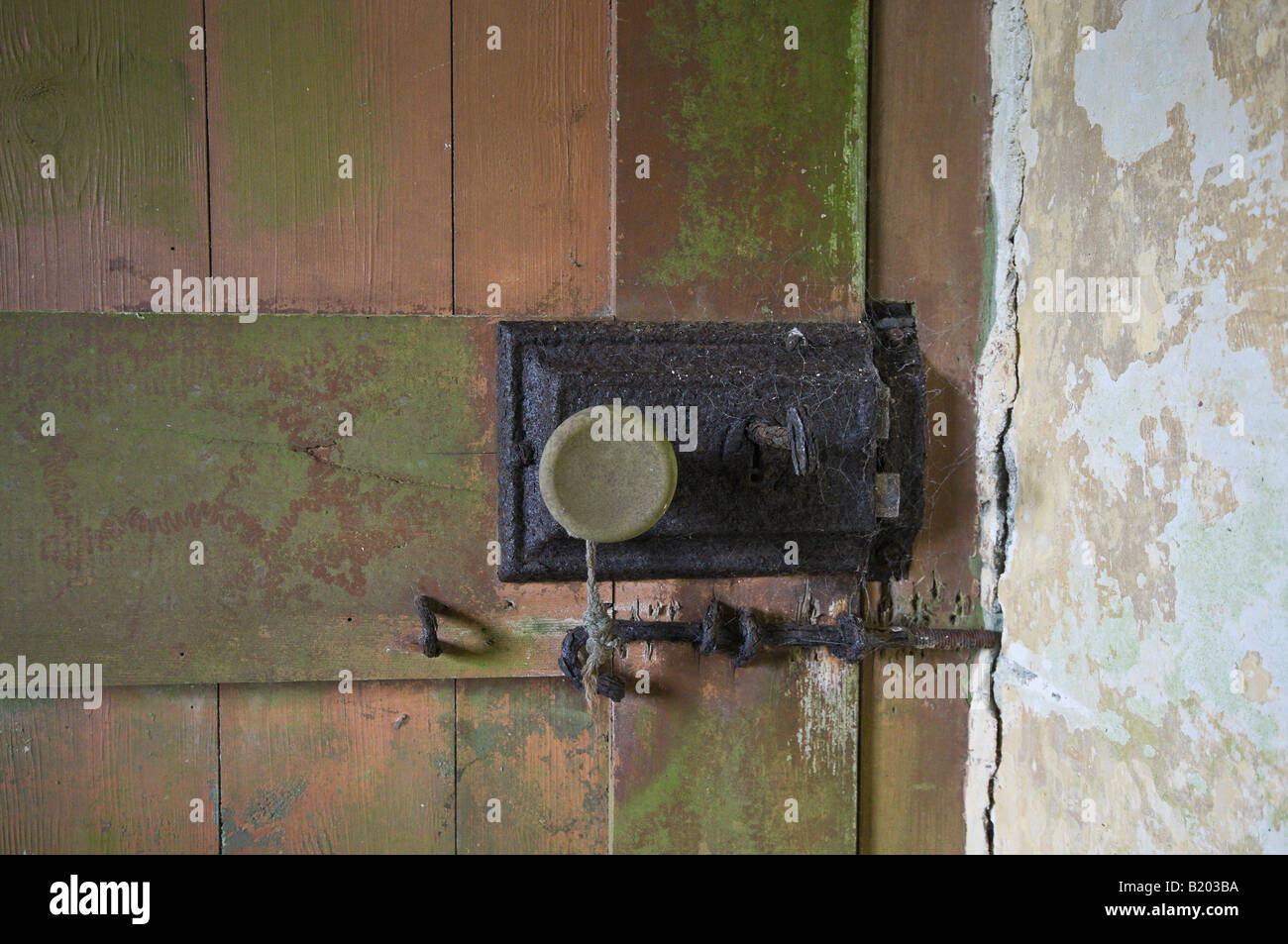 Rusty door lock on a moss covered door Stock Photo - Alamy