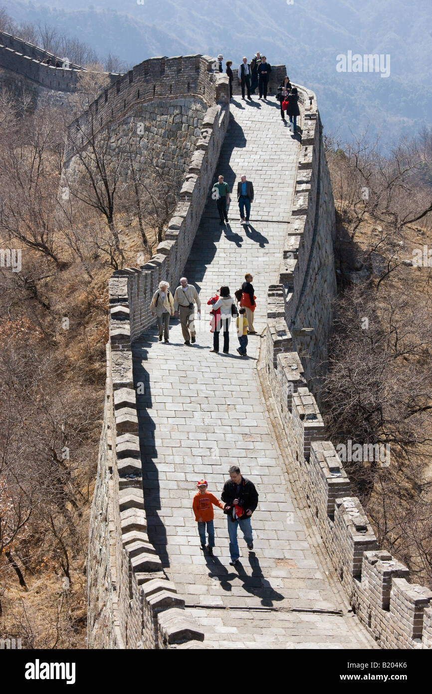Tourists walk the ancient Great Wall of China at Mutianyu north of ...