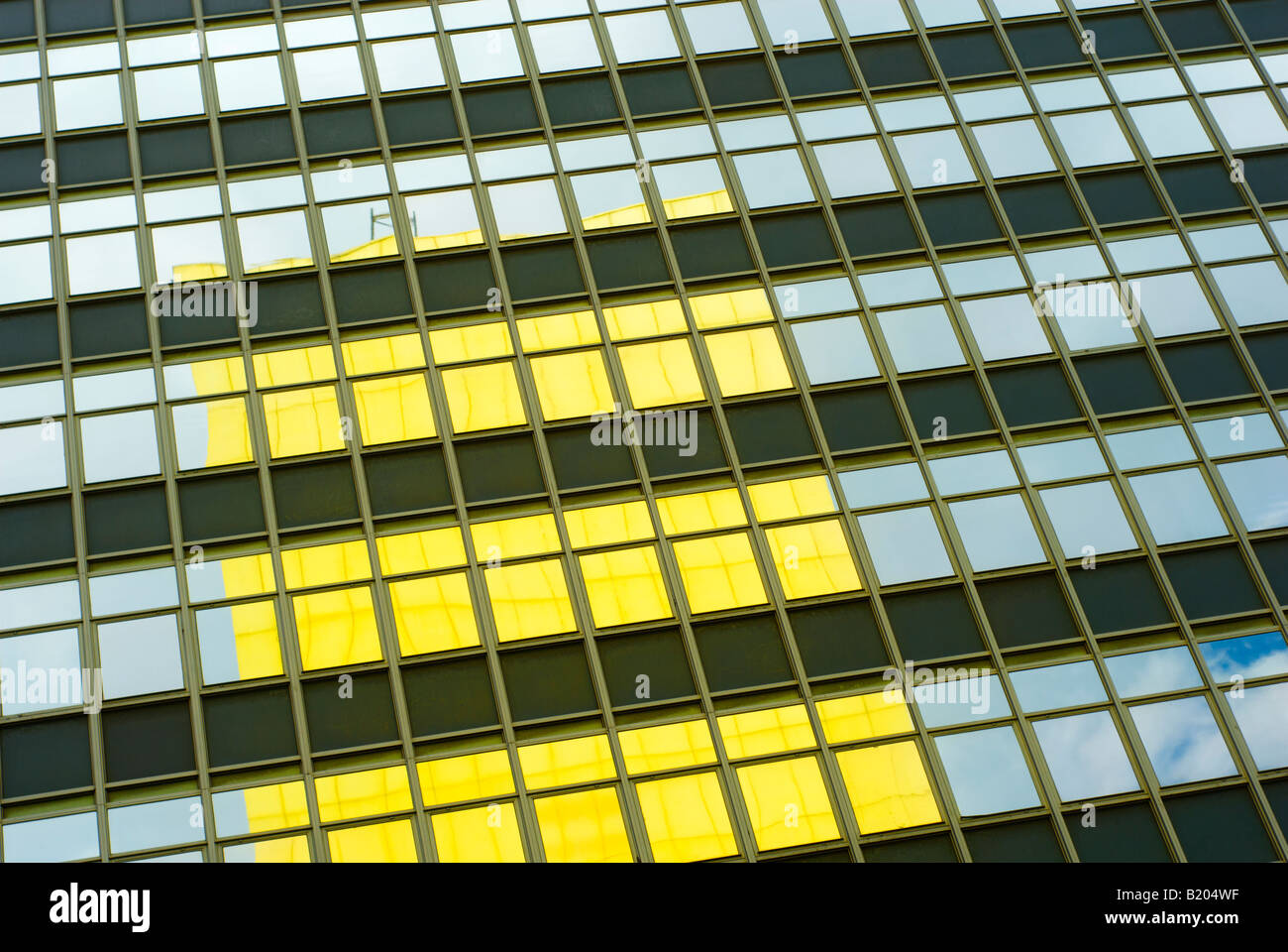 Yellow building reflected in the windows of a skyscraper Stock Photo ...