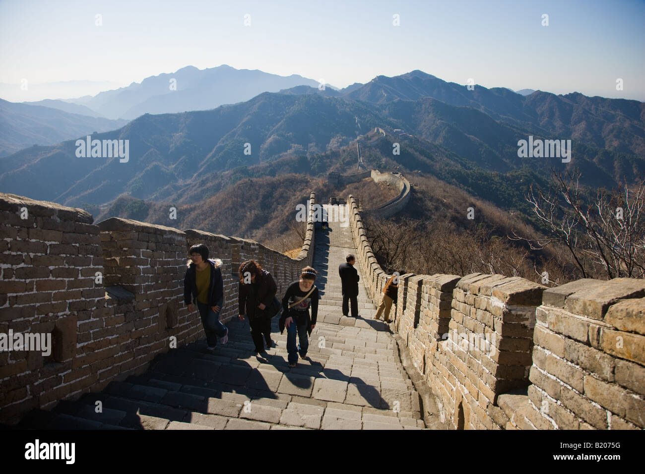 Tourists walk the ancient Great Wall of China at Mutianyu north of ...