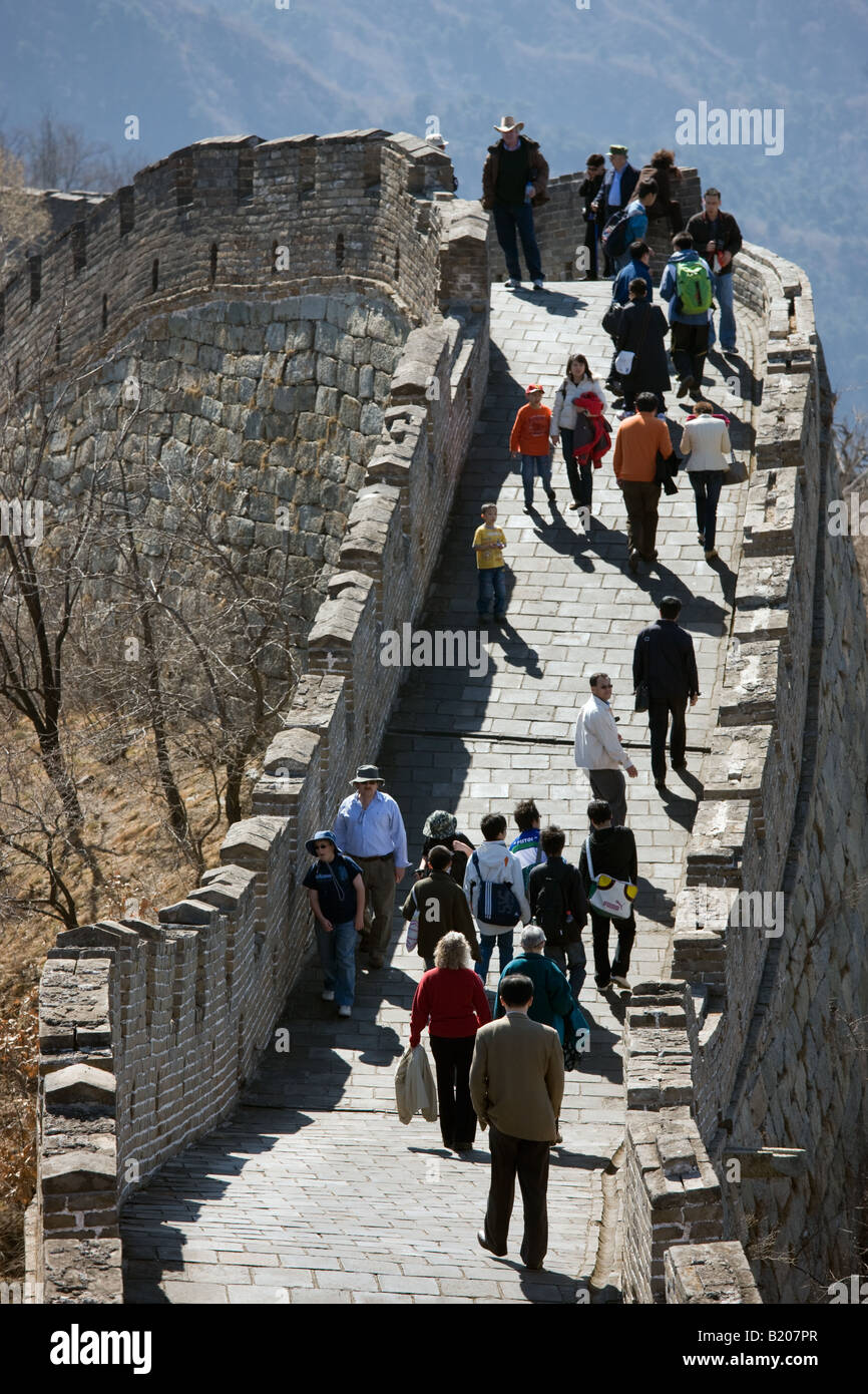 Tourists walk the ancient Great Wall of China at Mutianyu north of ...