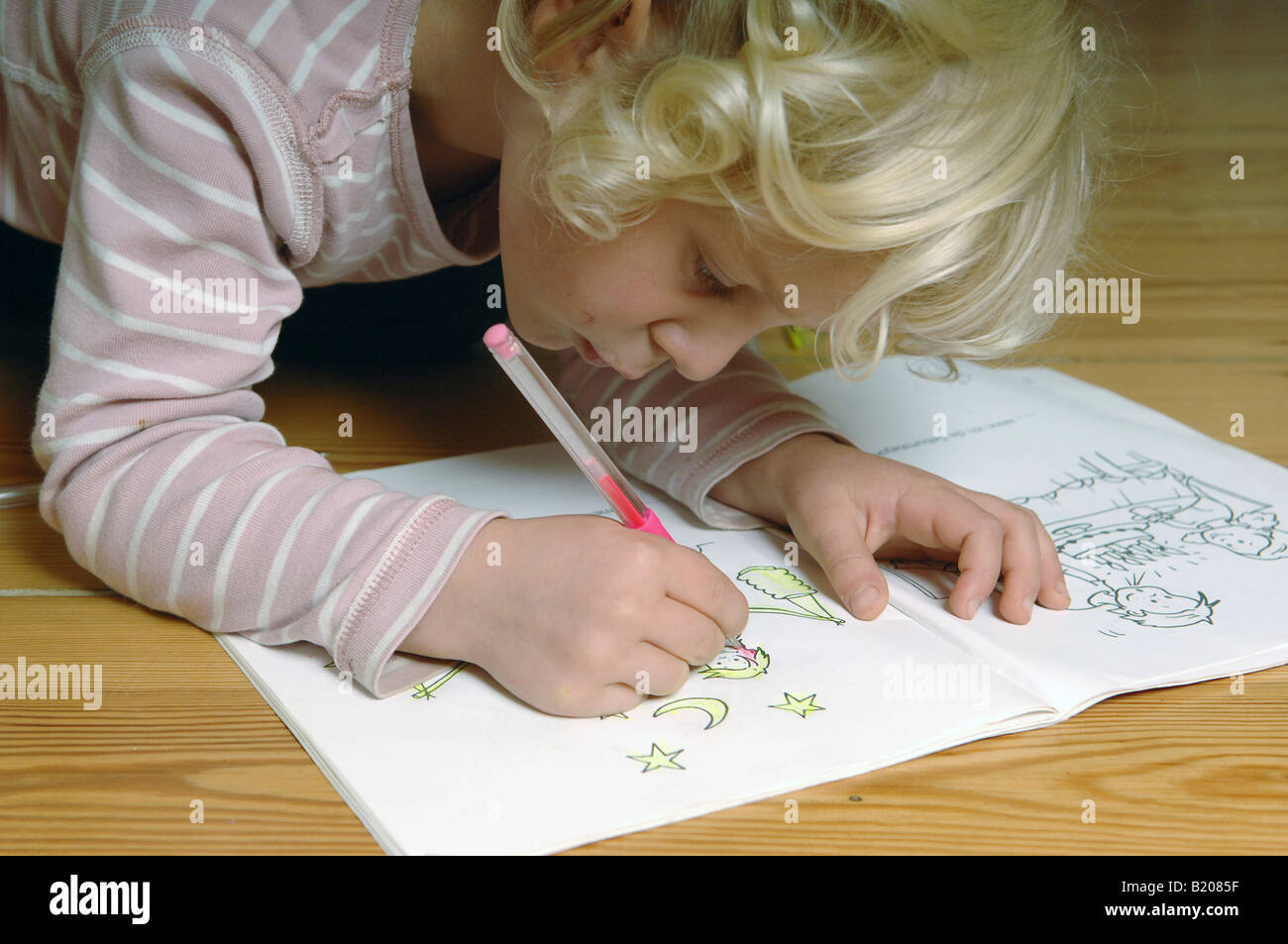 Child with a coloring book Stock Photo - Alamy