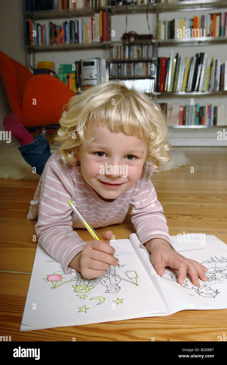 Child with a coloring book Stock Photo - Alamy