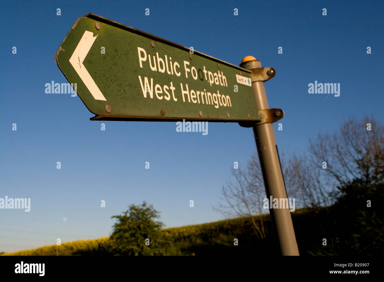 A footpath sign in England. The sign shows the public right of way ...