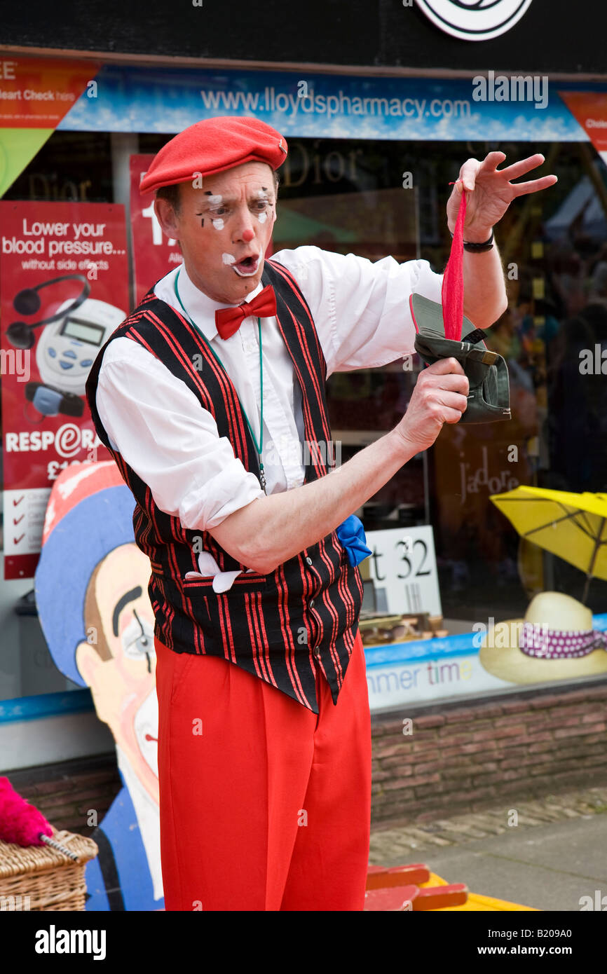 A clown providing street entertainment for children, Haslemere, Surrey ...